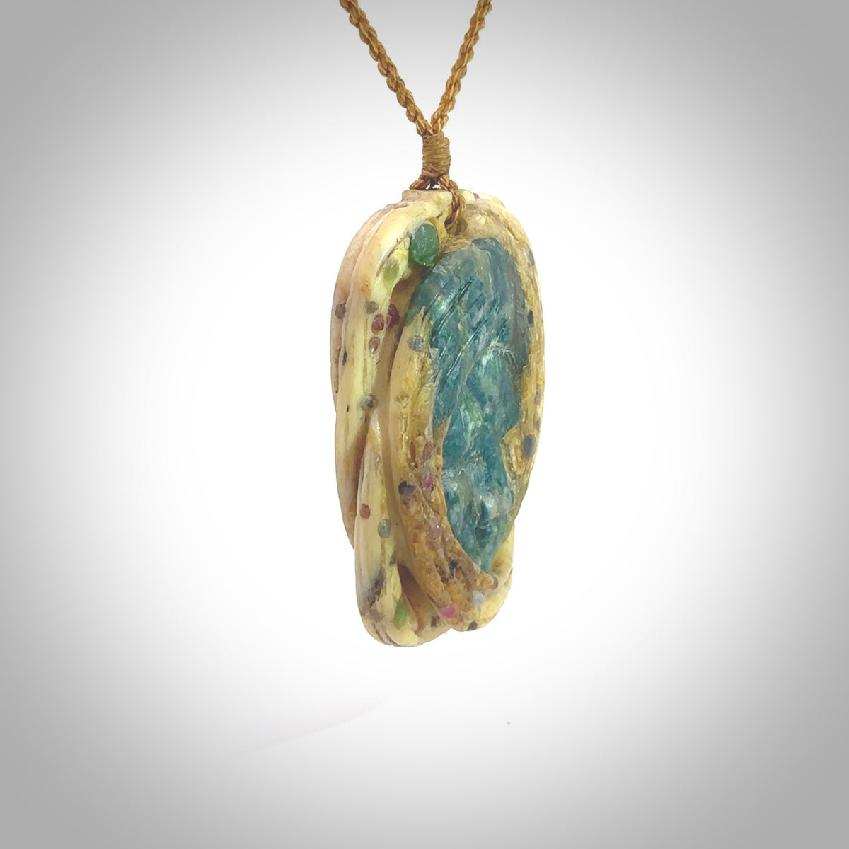 HAND MADE AOTEA STONE, WHALE BONE FACE PENDANT WITH RUBY AND SAPPHIRES ...