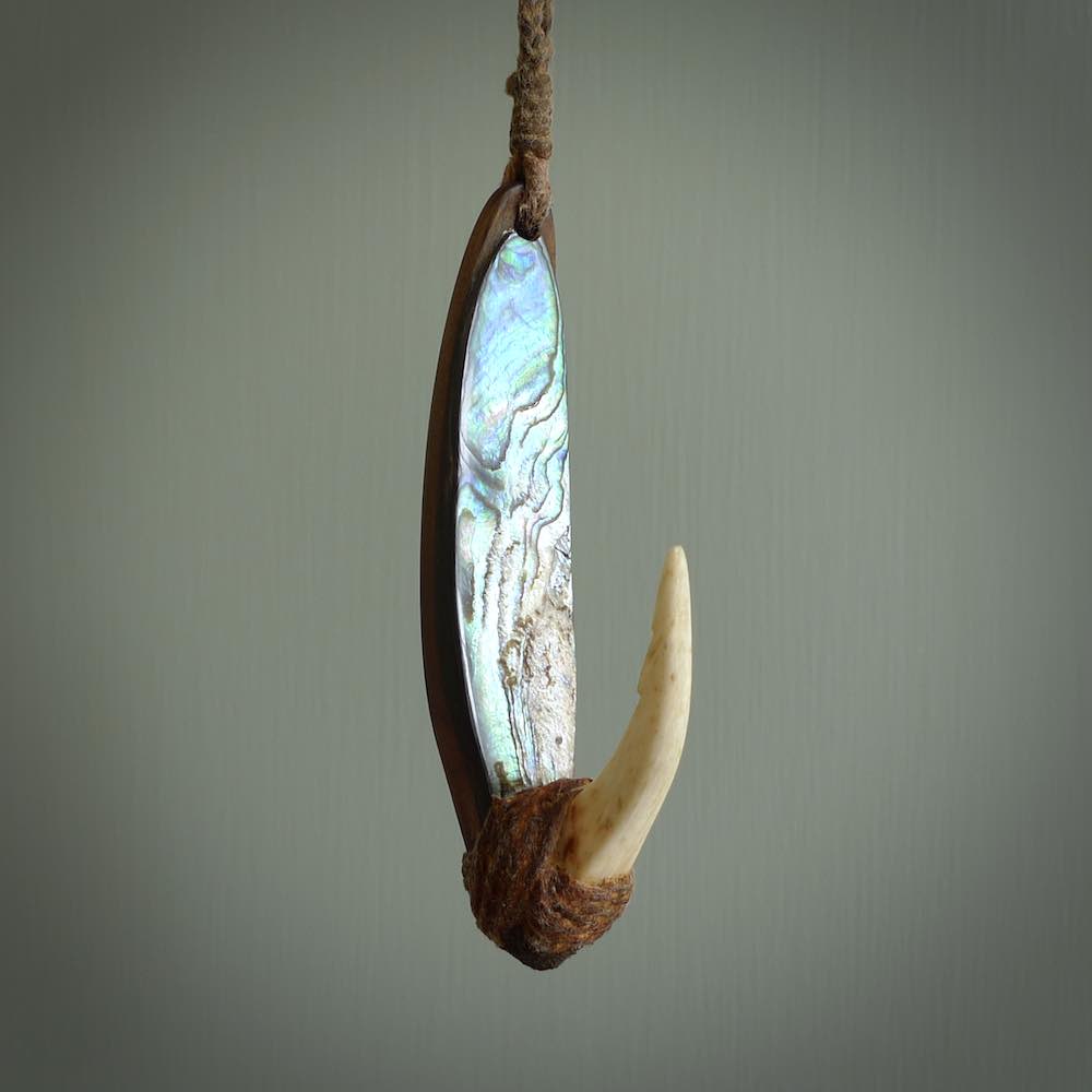HAND CARVED WHALE BONE, PAUA SHELL AND WOOD HOOK WITH DISPLAY STAND ...